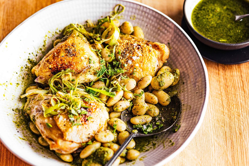 Crispy roast chicken thighs with herby white bean salad recipe